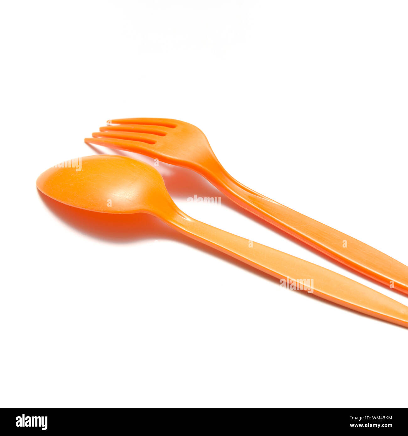 orange plastic spoon and fork Stock Photo - Alamy