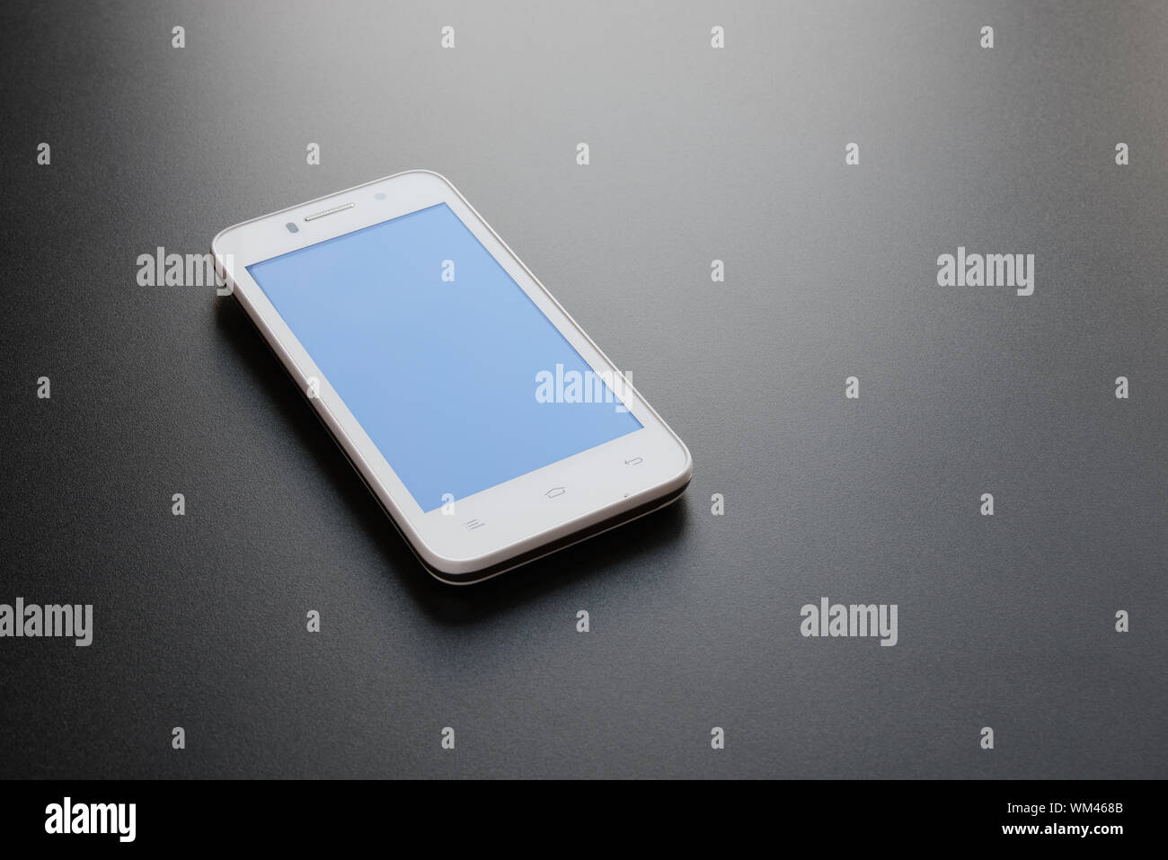 White Smart Phone With Blue Screen on the Black Table. Space for Text ...