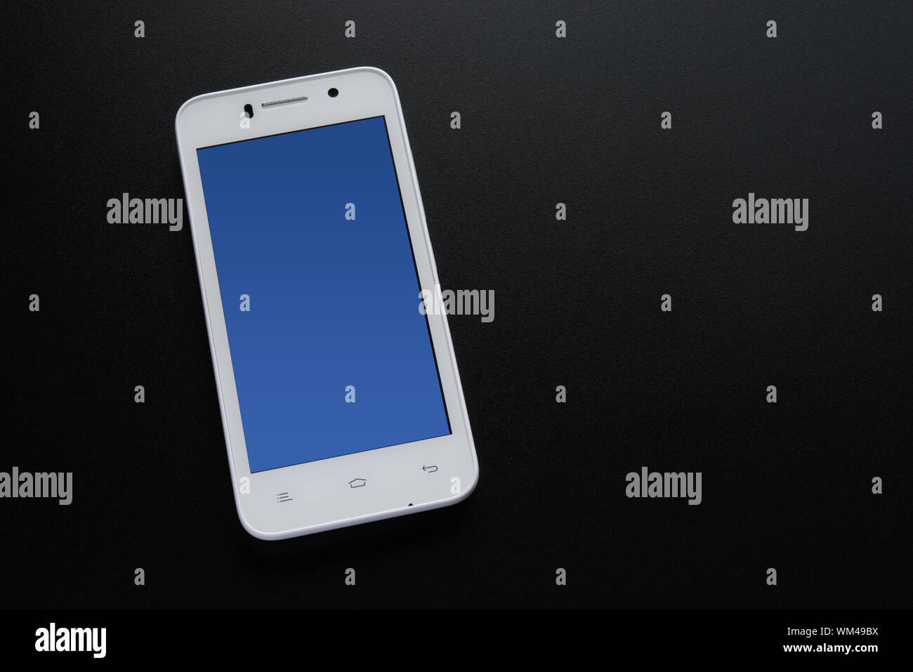 White Smart Phone With Blue Screen on the Black Table. Space for Text ...