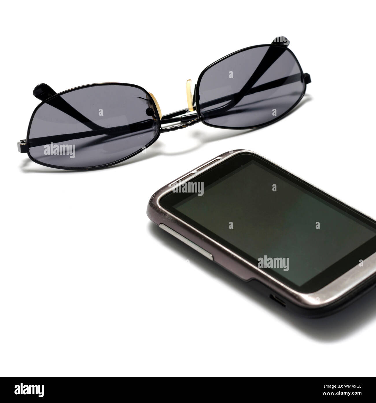 sunglasses with smart phone on a white background Stock Photo - Alamy