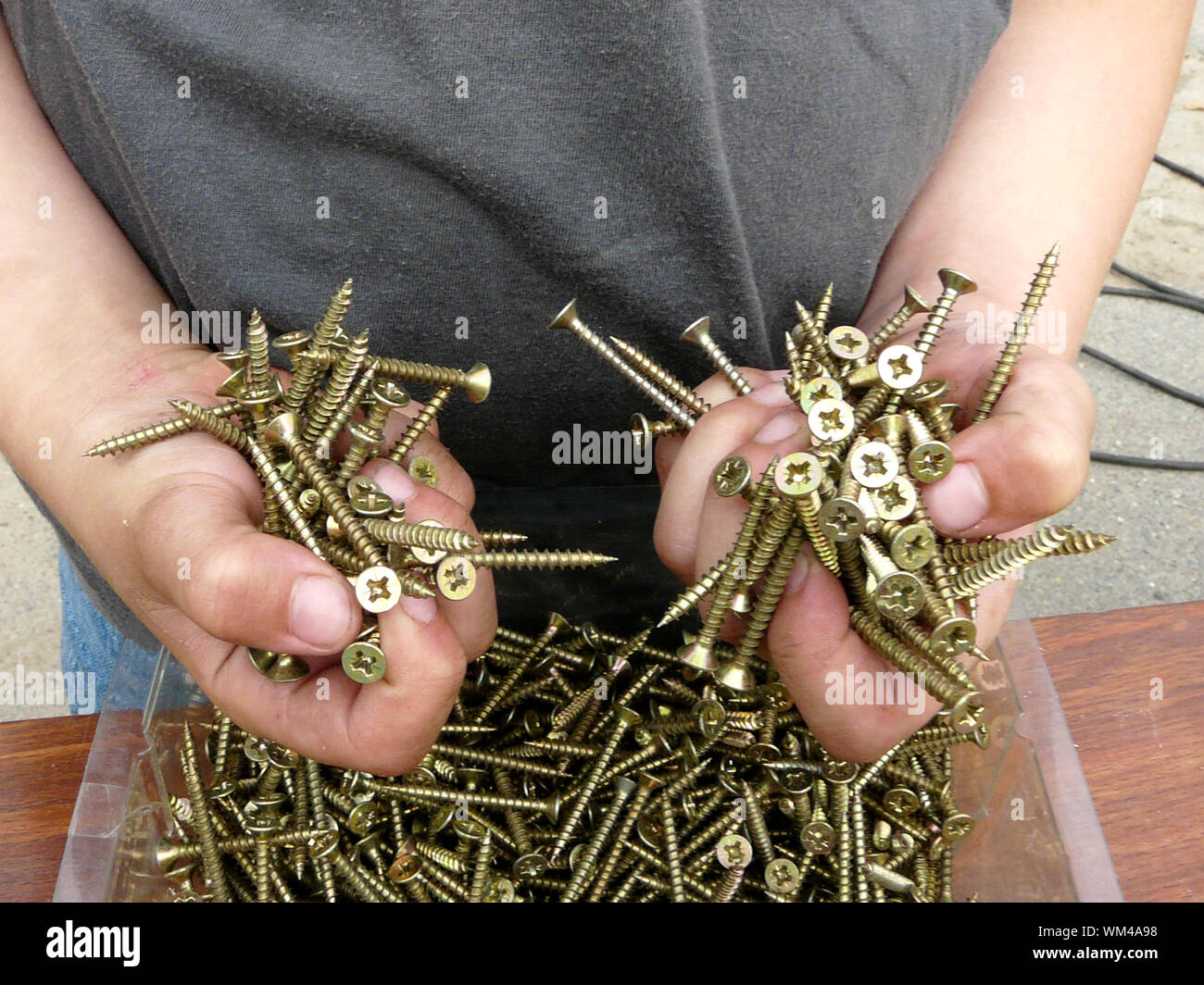 Hand holding screws hi-res stock photography and images - Alamy