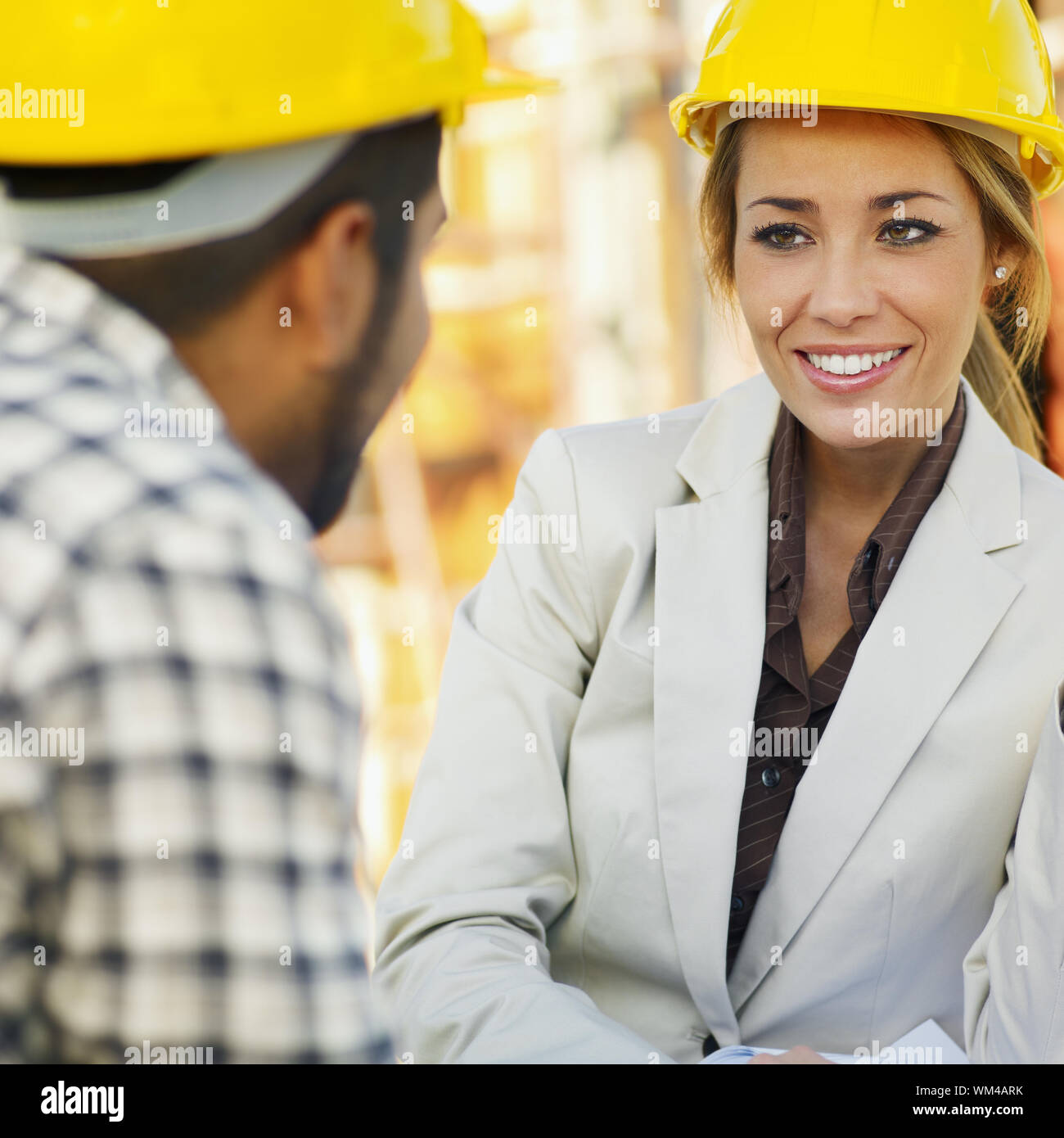 latin american construction worker and female architect talking Stock ...