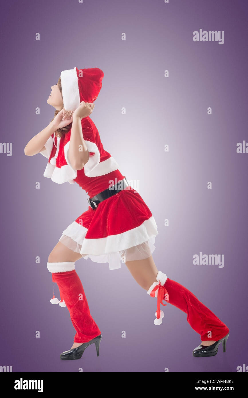 Christmas girl pull something, full length portrait Stock Photo - Alamy