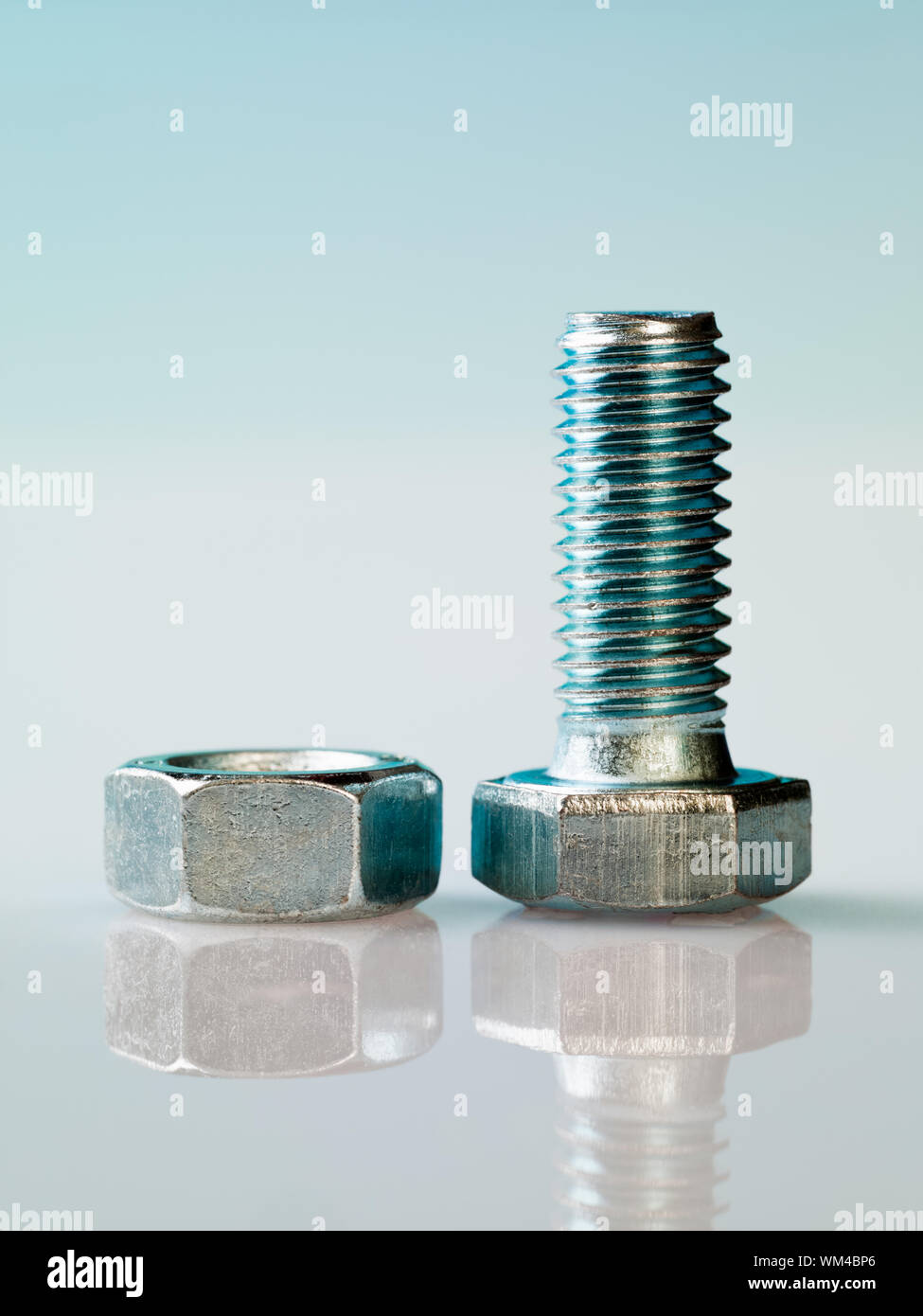 screw bolt on graduated cyan background. Copy space Stock Photo - Alamy