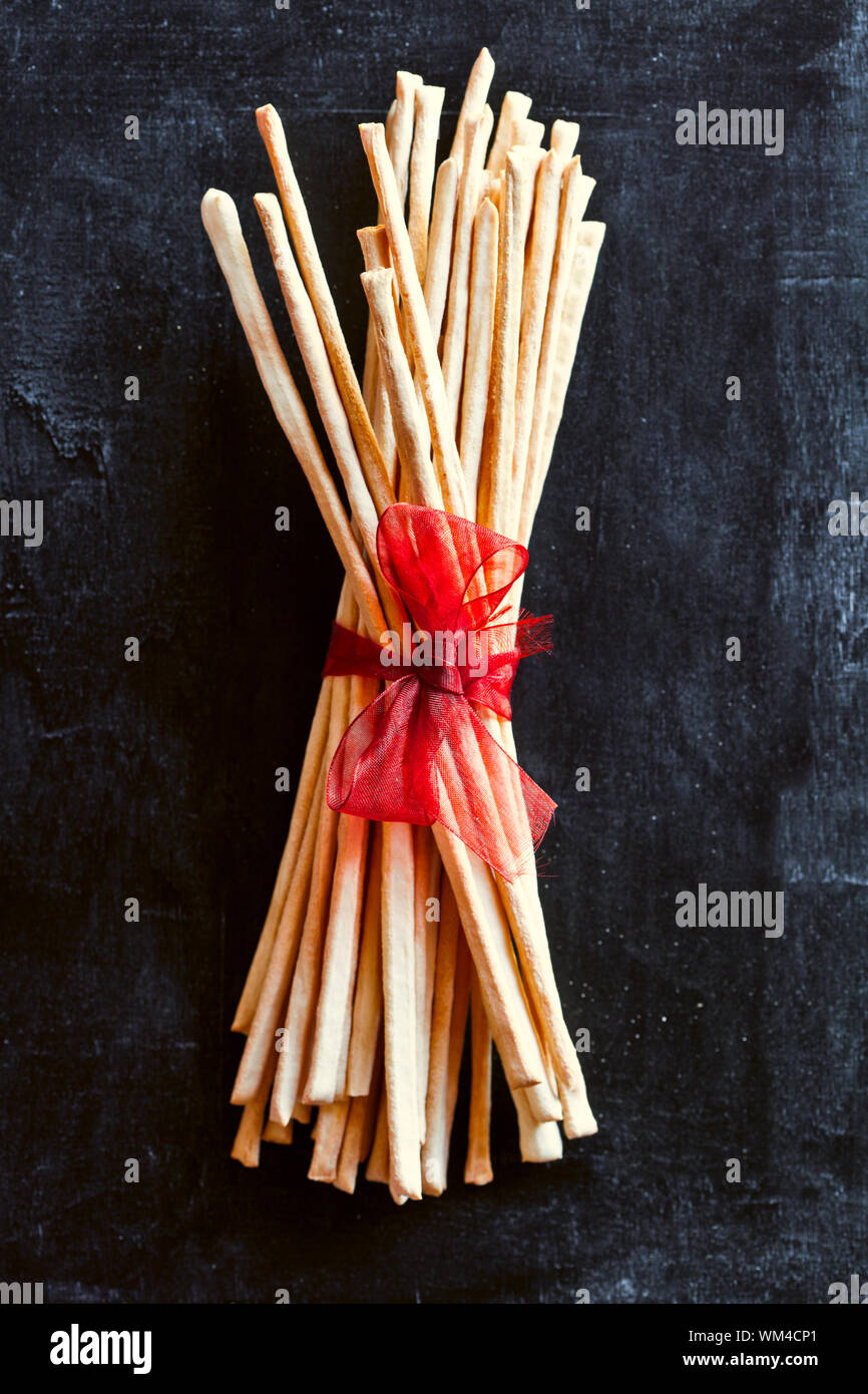 top view of breadsticks grissini torinesi on blackboard background ...