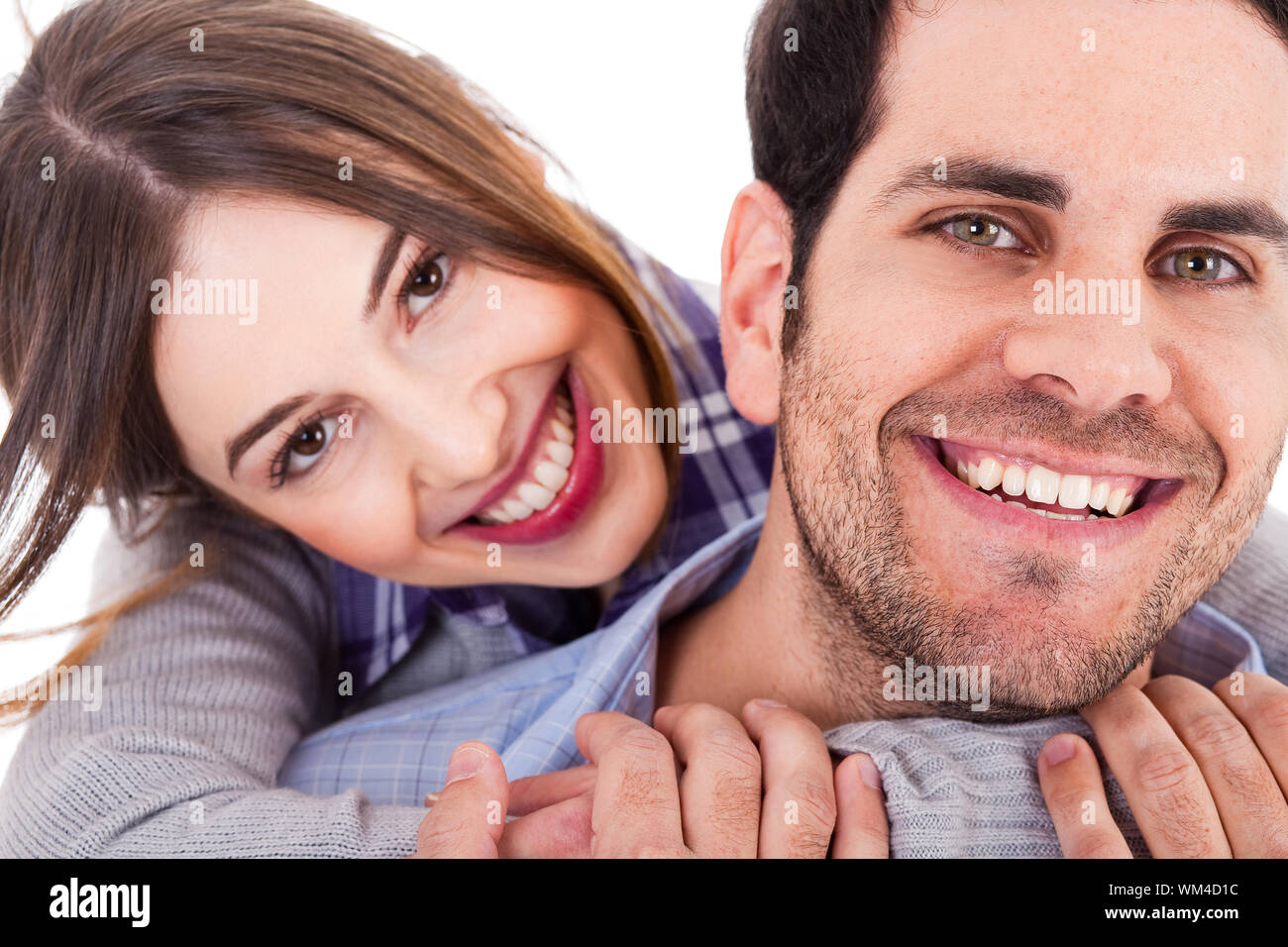 Cute girl holding her hands round the neck of her boyfriend and smiling ...