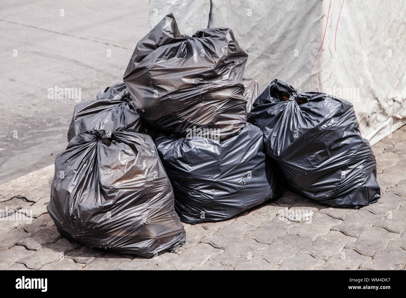Garbage bag on sidewalk hi-res stock photography and images - Alamy