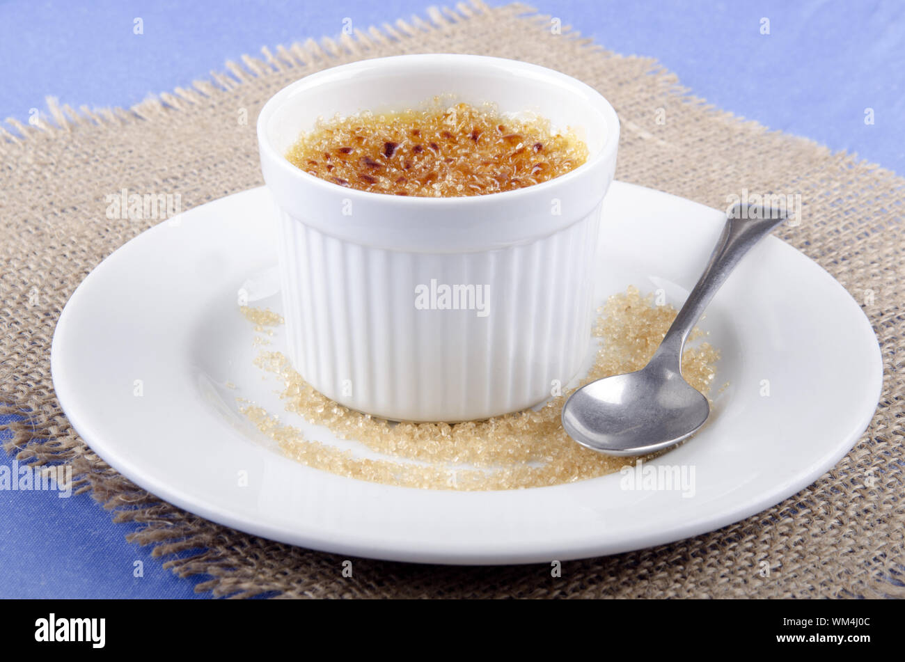 creme brulee in a porcelain bowl and spoon Stock Photo - Alamy