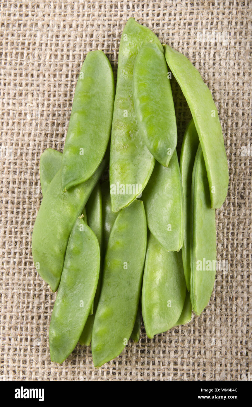 organic pea pod on brown jute cloth Stock Photo - Alamy