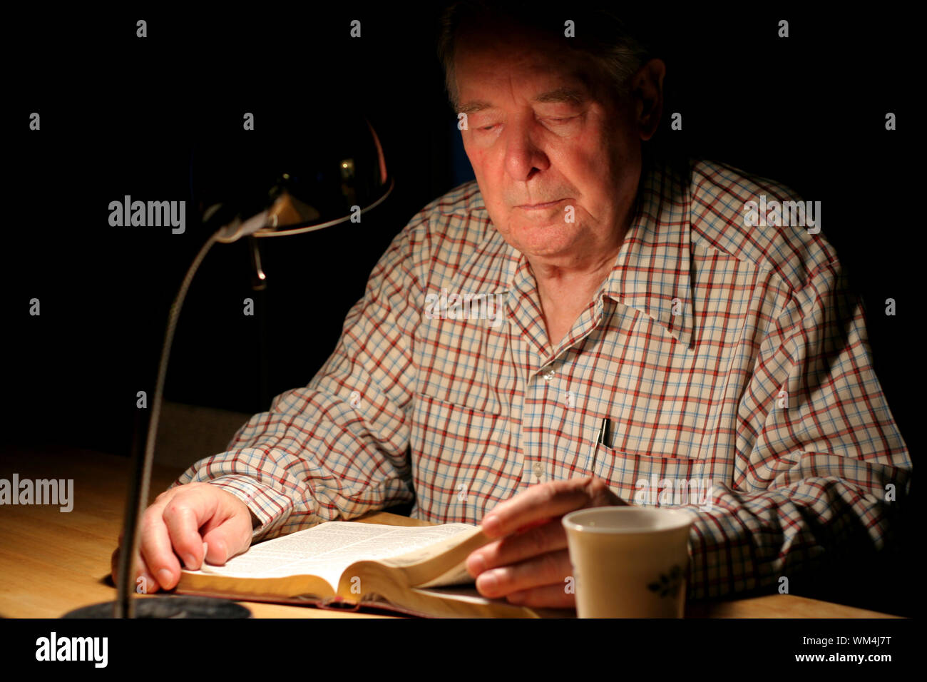 Old man holding bible hi-res stock photography and images - Alamy