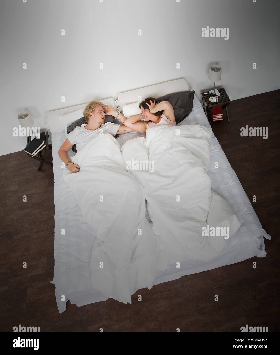 Angry wife and snoring man in the bedroom Stock Photo - Alamy