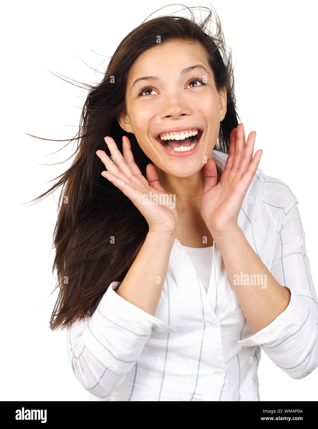 Portrait of surprised young woman looking surprised and happy up ...