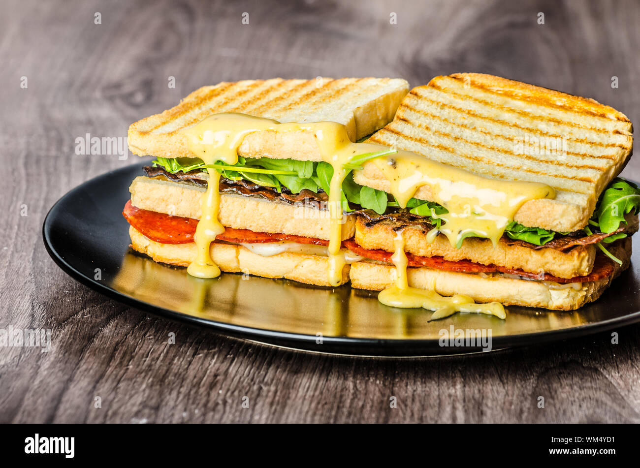 Three floor Panini toast with bacon, arugula, pepperoni salami and ...