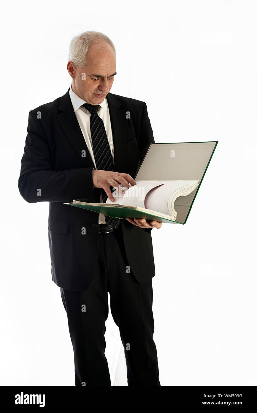 A concerned businessman who looks into a file folder Stock Photo - Alamy