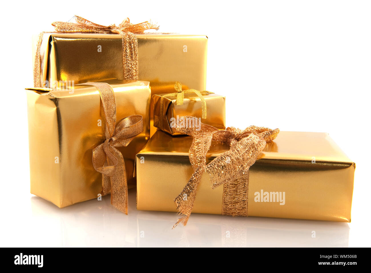 Golden luxury wrapped christmas presents isolated over white Stock ...
