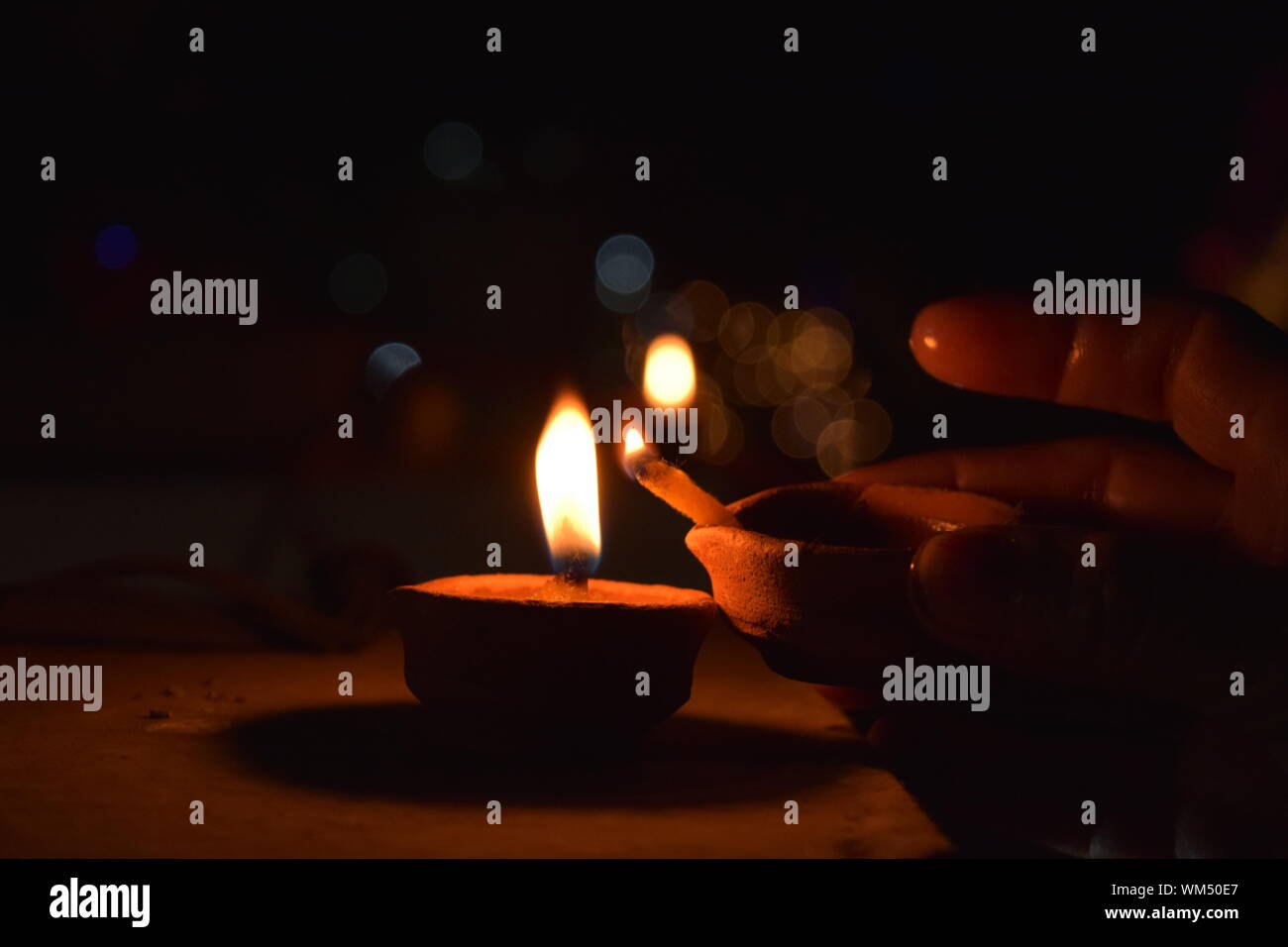 Hand holding diya hi-res stock photography and images - Alamy