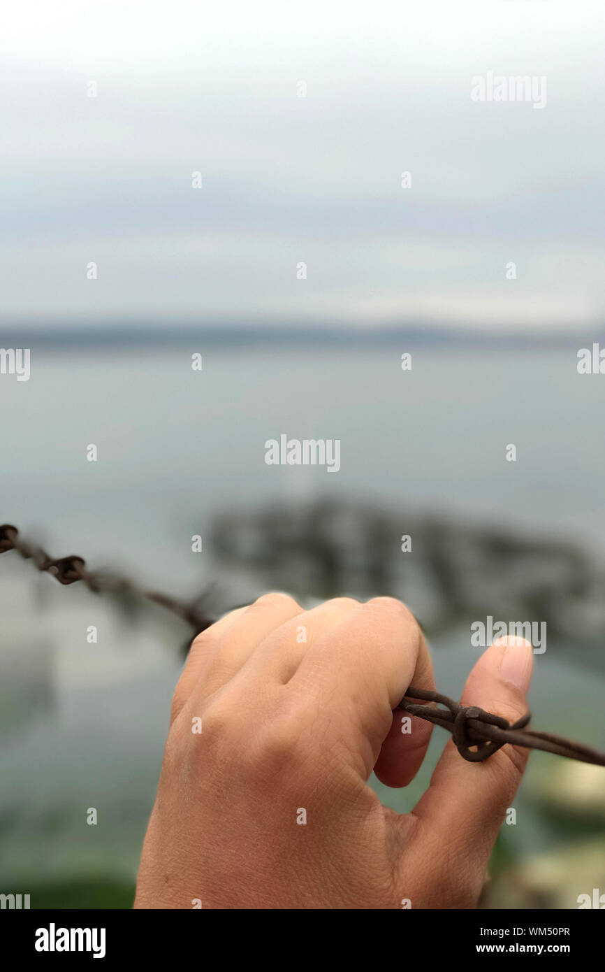 Hand with barbed wire hi-res stock photography and images - Alamy