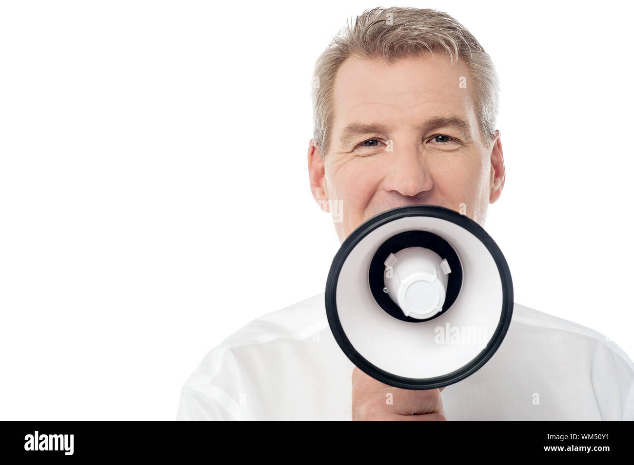 Mature man proclaiming into megaphone, advertising Stock Photo - Alamy