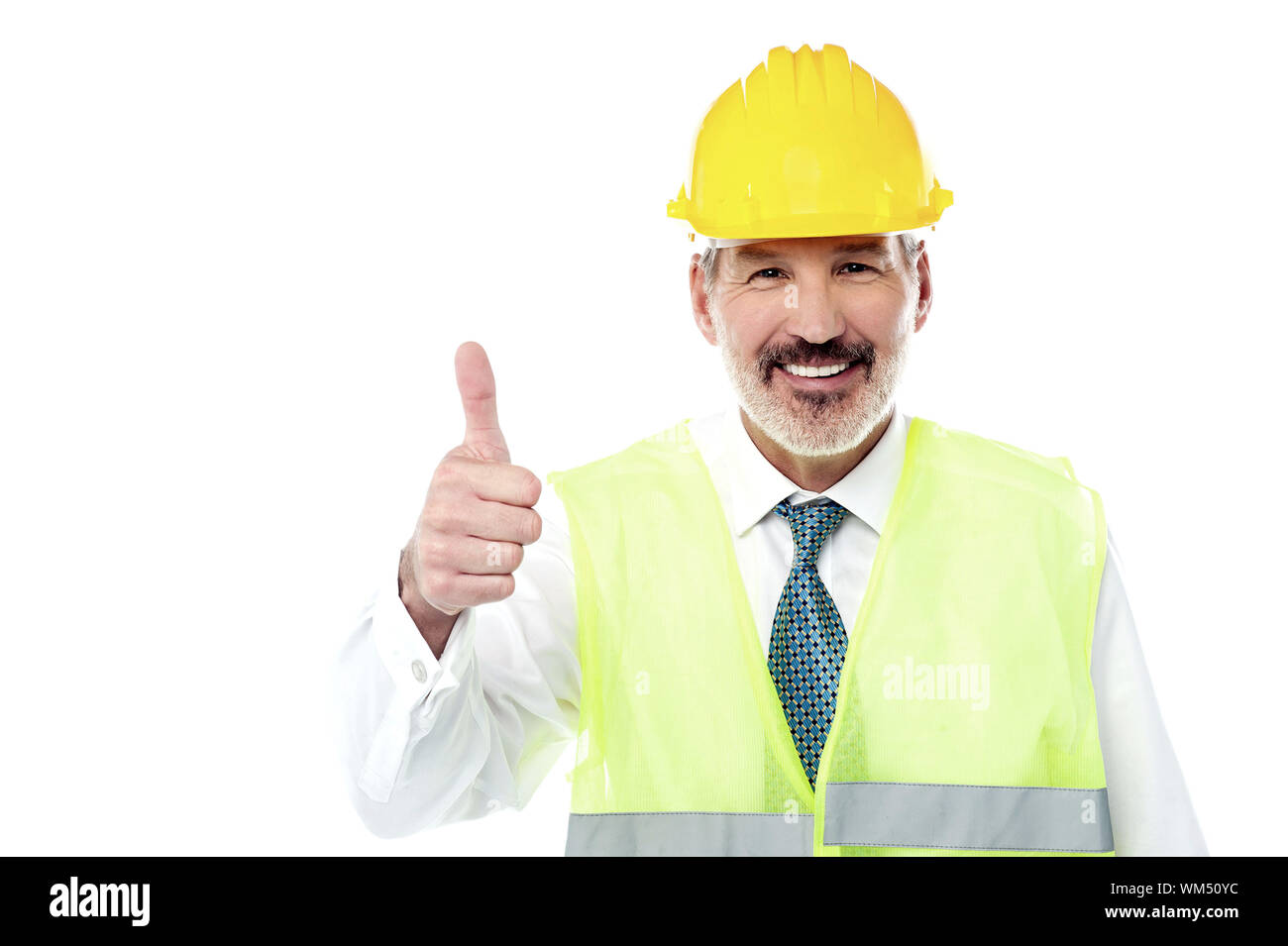 Happy engineer with hardhat showing thumbs up Stock Photo - Alamy