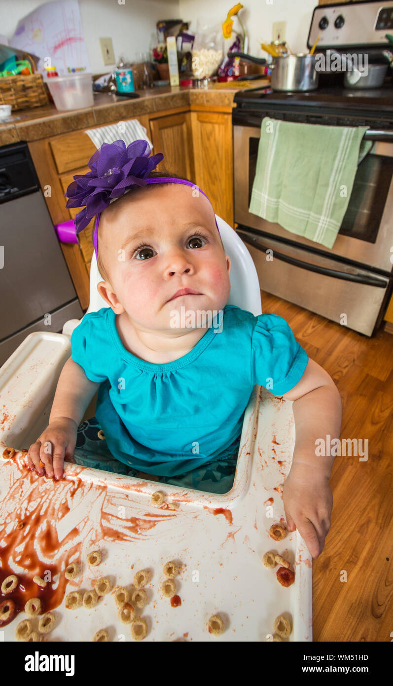 Curious baby in kitchen is looking upwards Stock Photo - Alamy