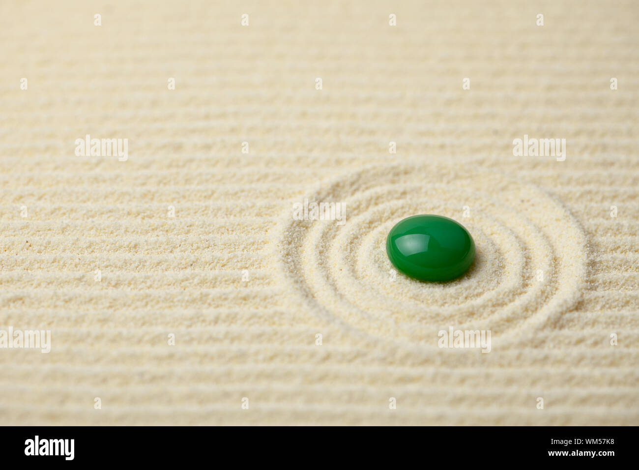 Green big glass drop on sand surface Stock Photo - Alamy
