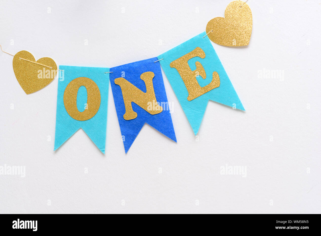 Happy Birthday One Year Flag Garland gold and blue color on white wall ...