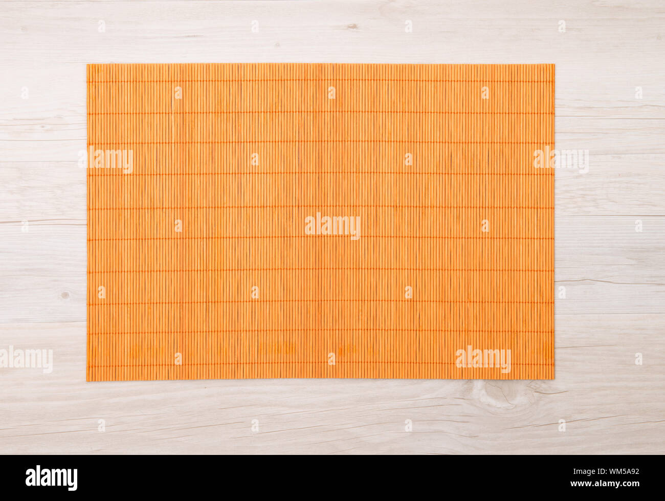 Bamboo place mat on wooden deck table Stock Photo - Alamy