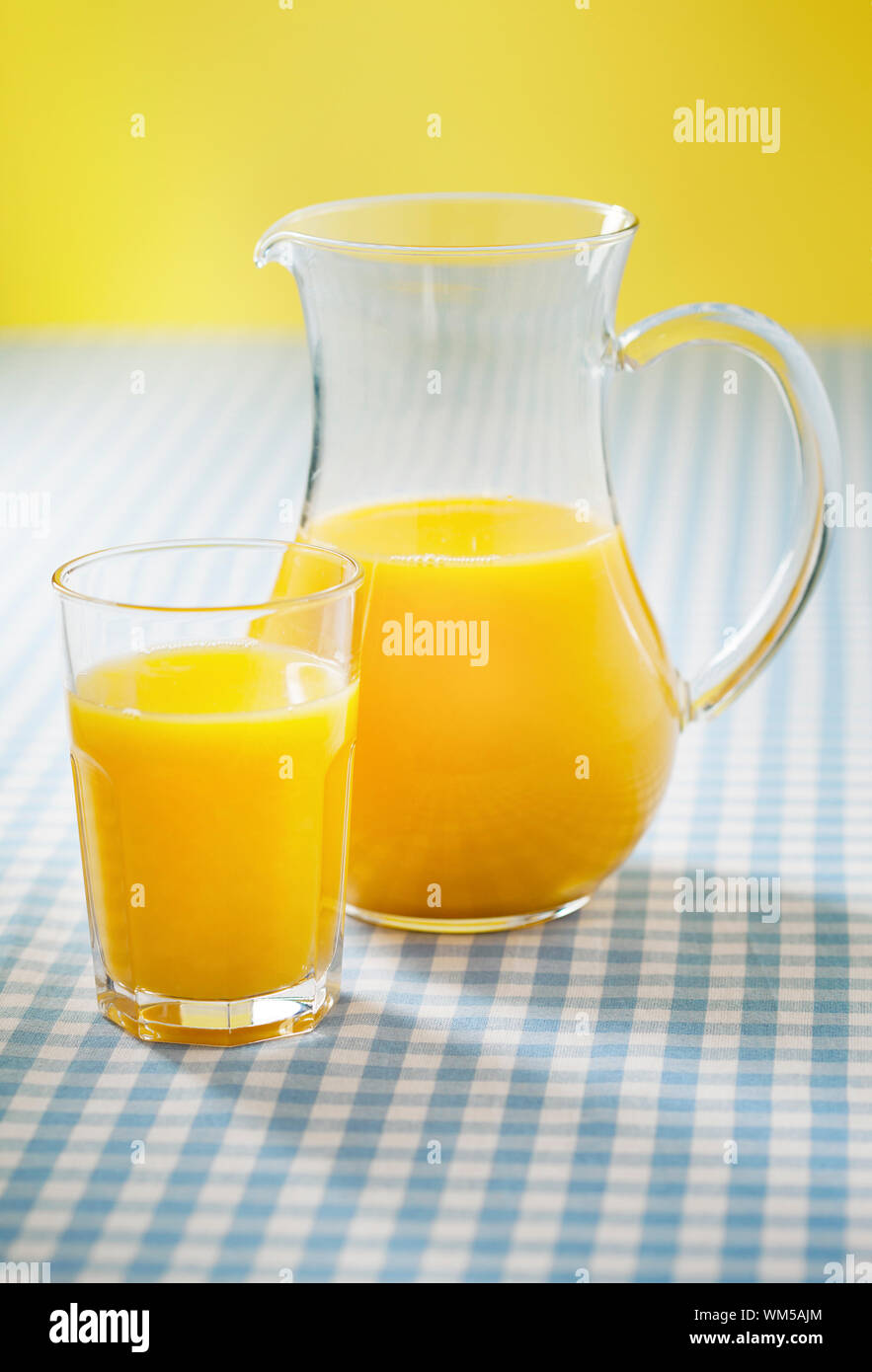 A glass and pitcher with orange juice. Short depth-of-field Stock Photo ...