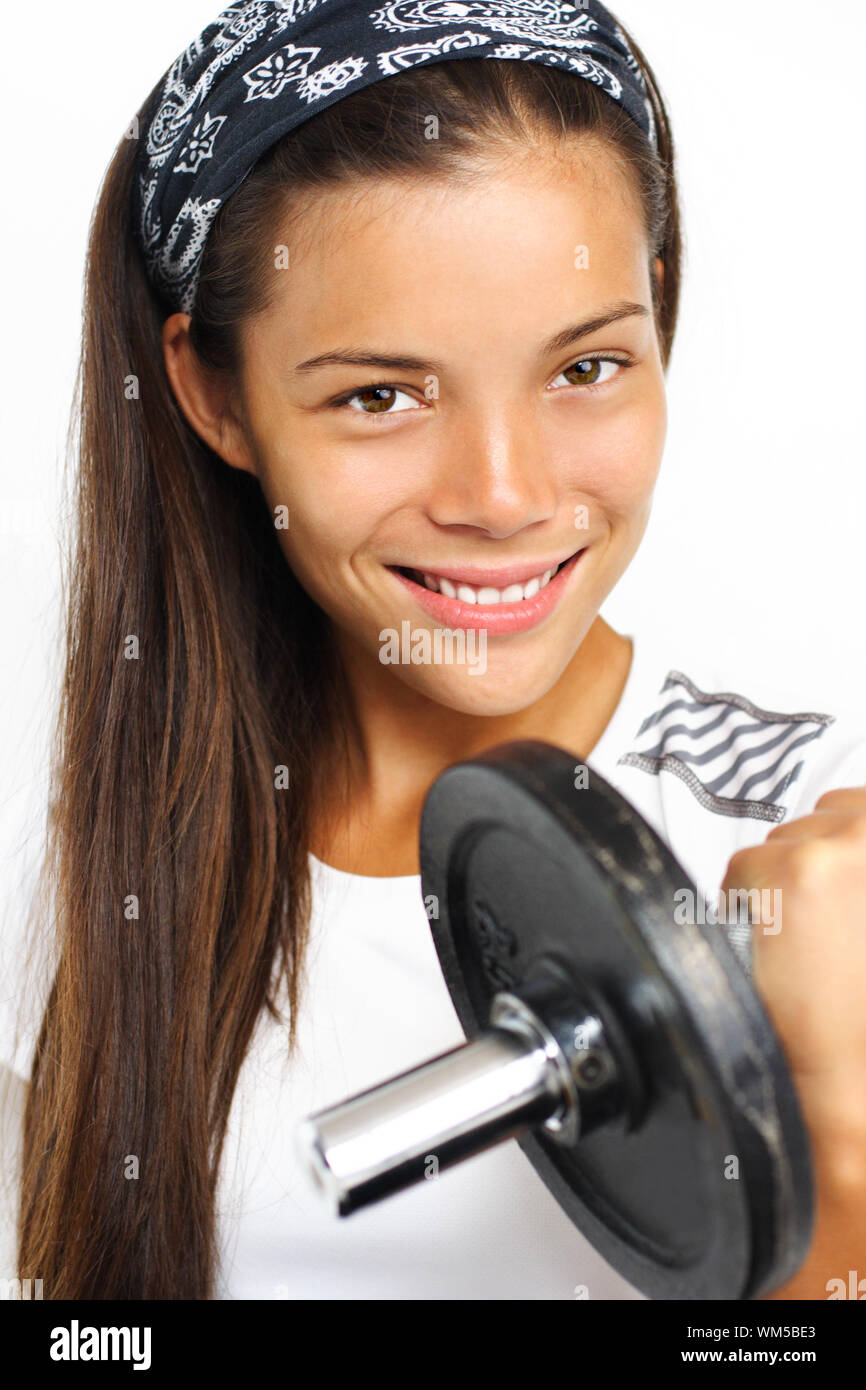 Fitness woman. Attractive woman lifting weights and smiling at the ...