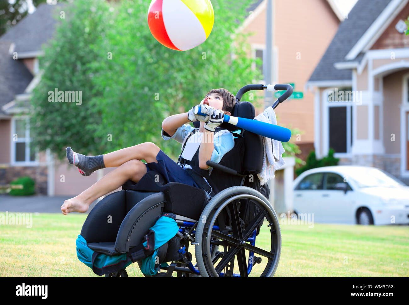 Disabled little boy playing ball in the park Stock Photo - Alamy