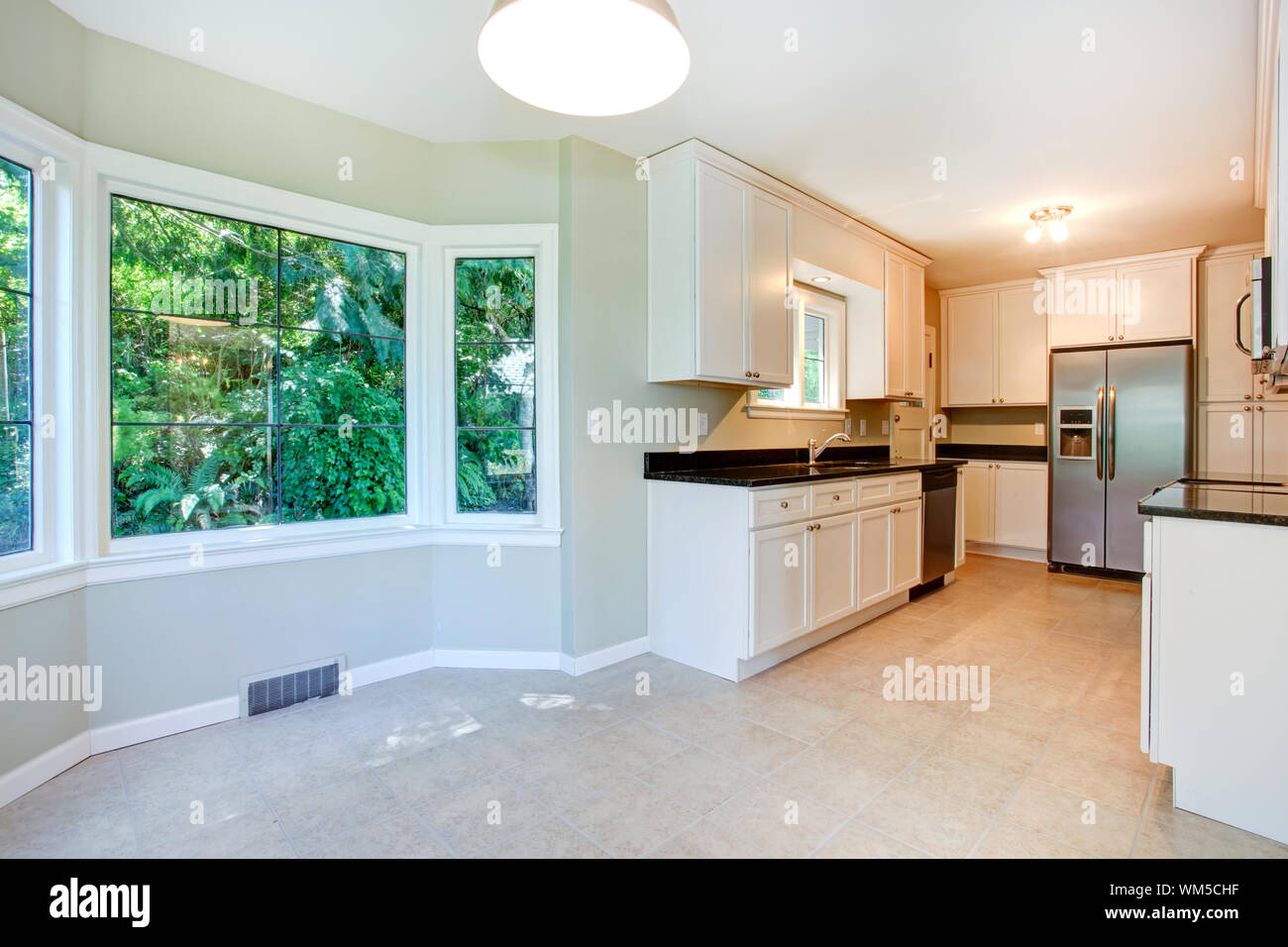 Bright empty dining room interior with tile floor and round corner ...