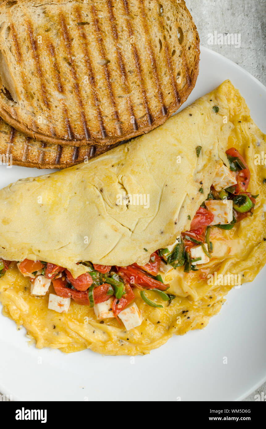 Mediterranean-Style Omlette with crispy garlic bread and apple juice ...