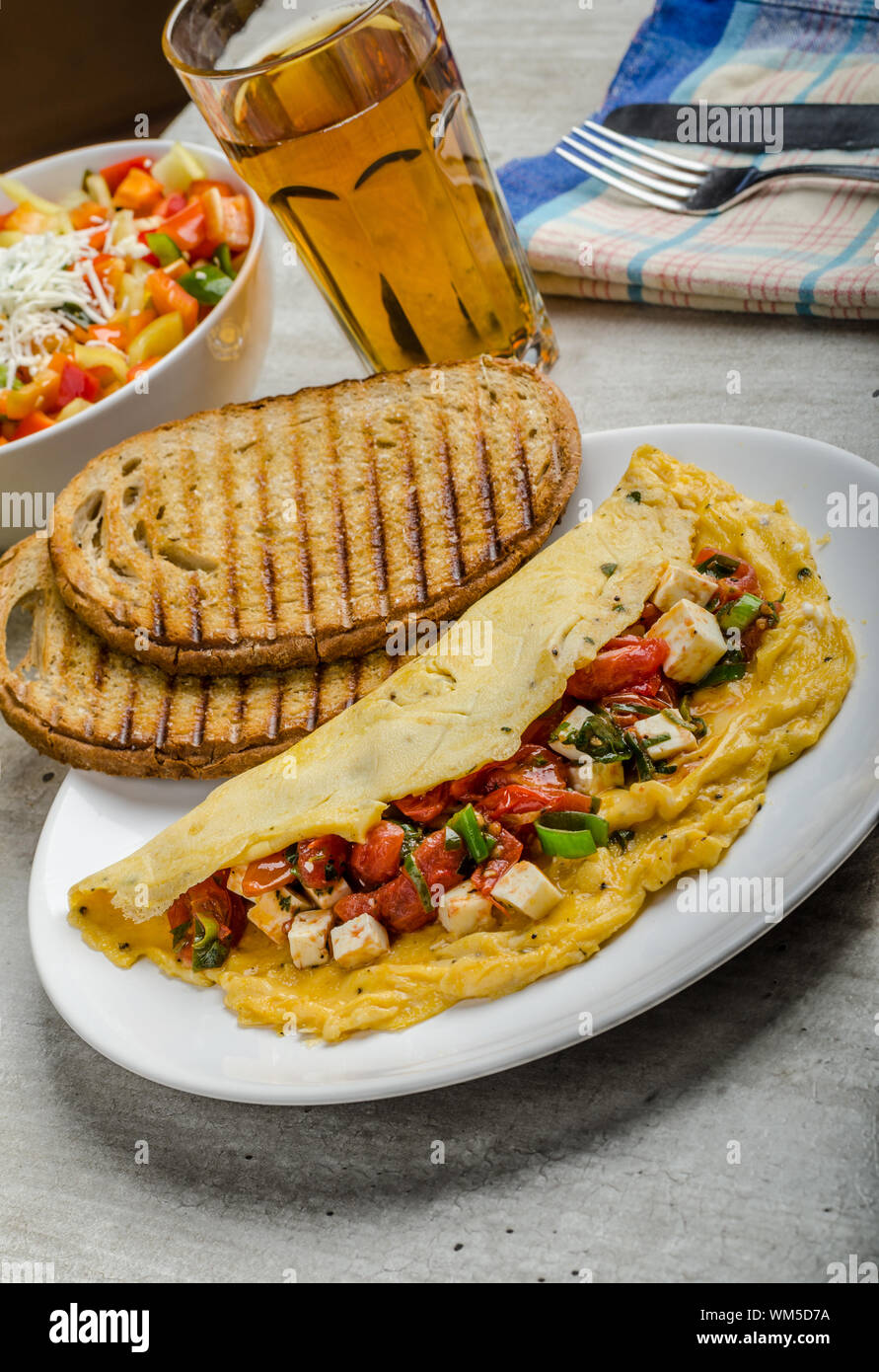 Mediterranean-Style Omlette with crispy garlic bread and apple juice ...