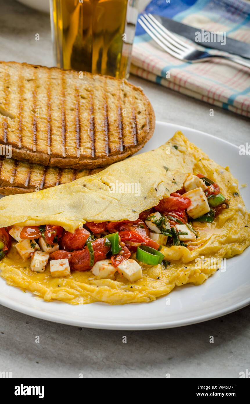Mediterranean-Style Omlette with crispy garlic bread and apple juice ...