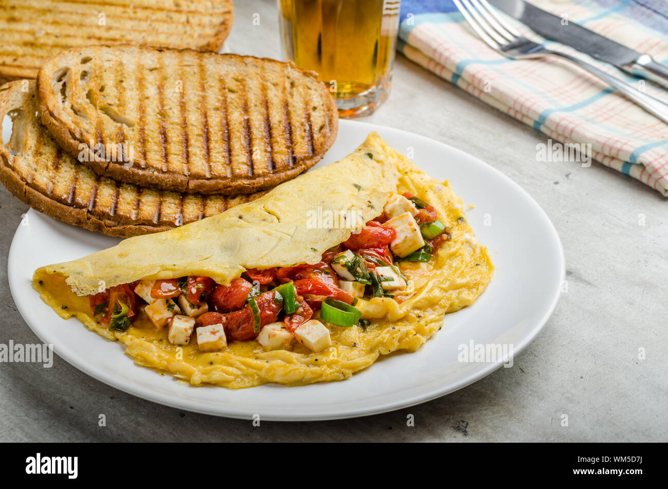 Mediterranean-Style Omlette with crispy garlic bread and apple juice ...