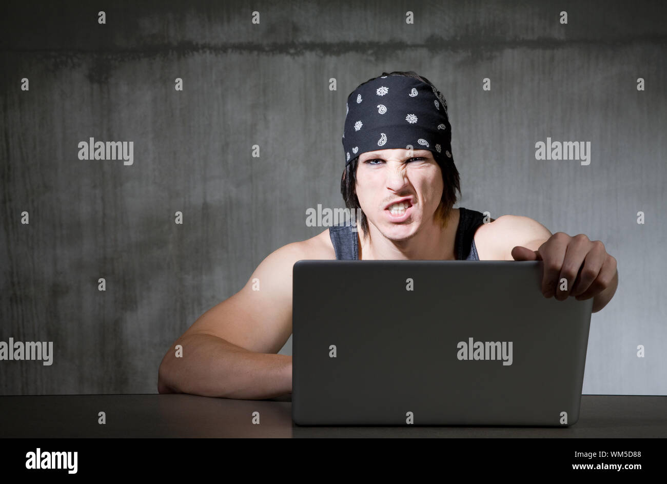 Muscular man holding laptop hi-res stock photography and images - Alamy