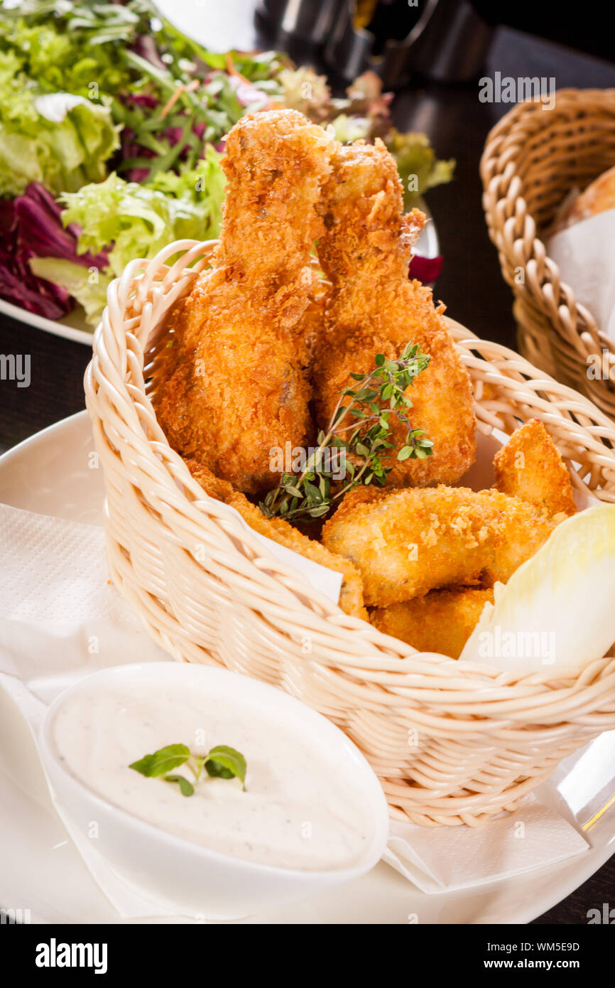 Crisp crunchy golden chicken legs and wings Stock Photo - Alamy