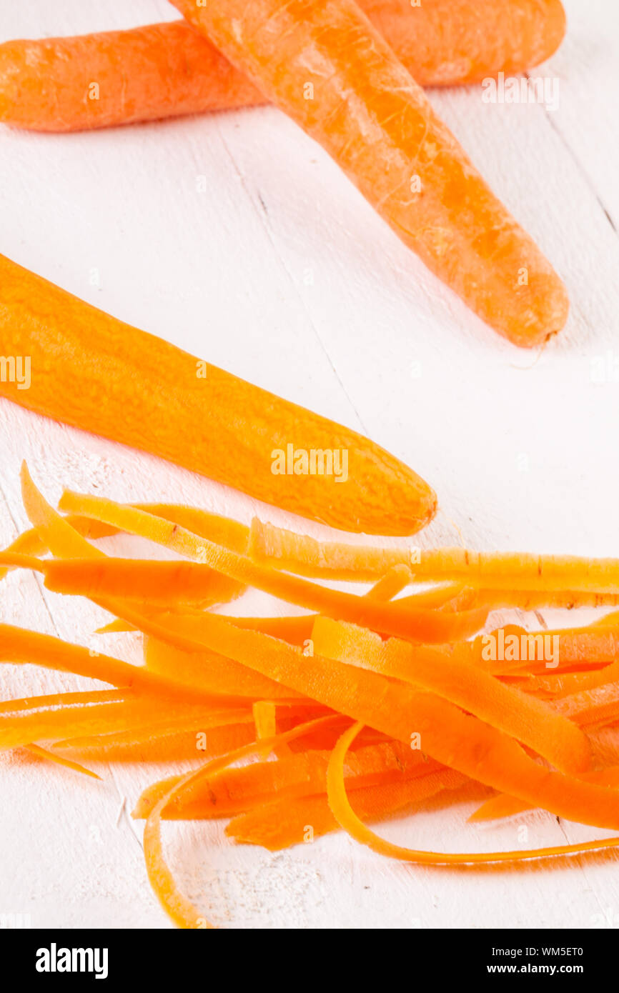 Fresh peeled carrots sliced into thin batons for carrot julienne with a ...