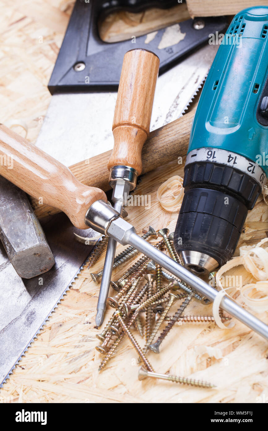 Battery-operated portable hand drill with timber, screwdrivers and ...