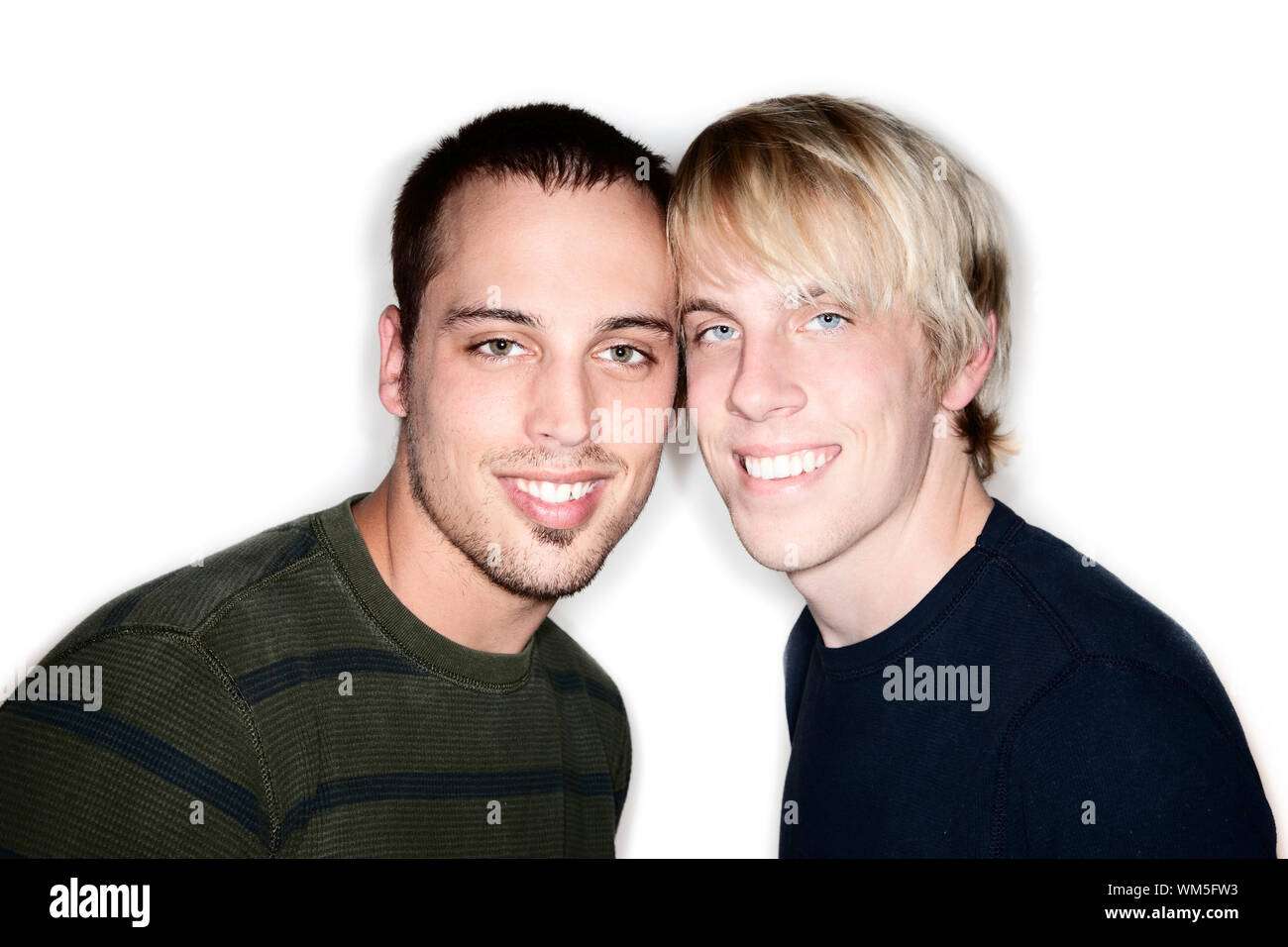 Two handsome men posing for portrait on white background Stock Photo ...