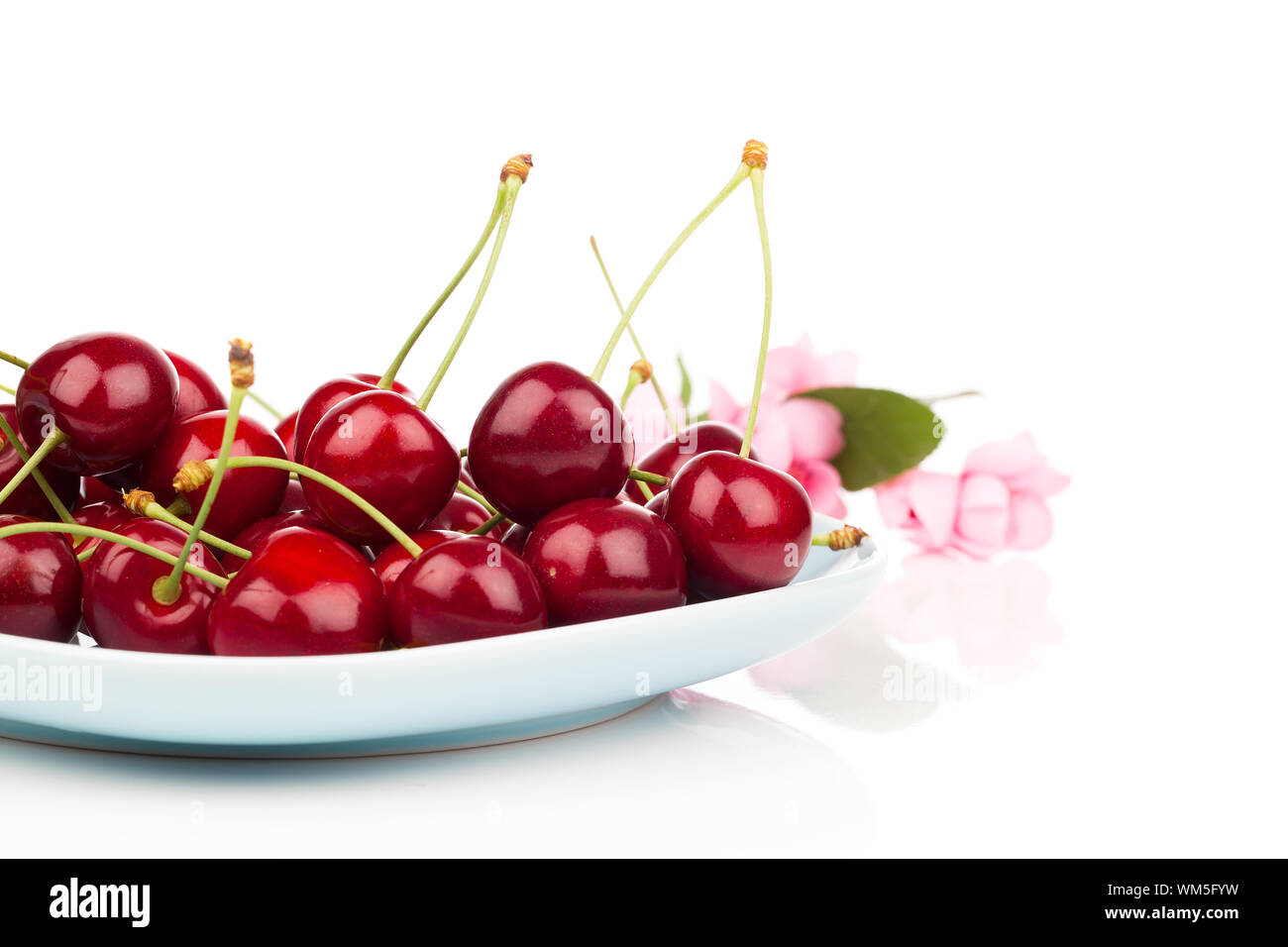 Bowl full of cherries isolated on white background Stock Photo - Alamy