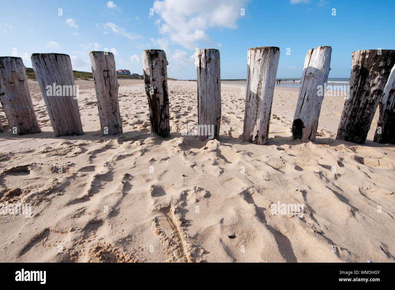 Beach with wooden weave breakers in landscape Stock Photo - Alamy