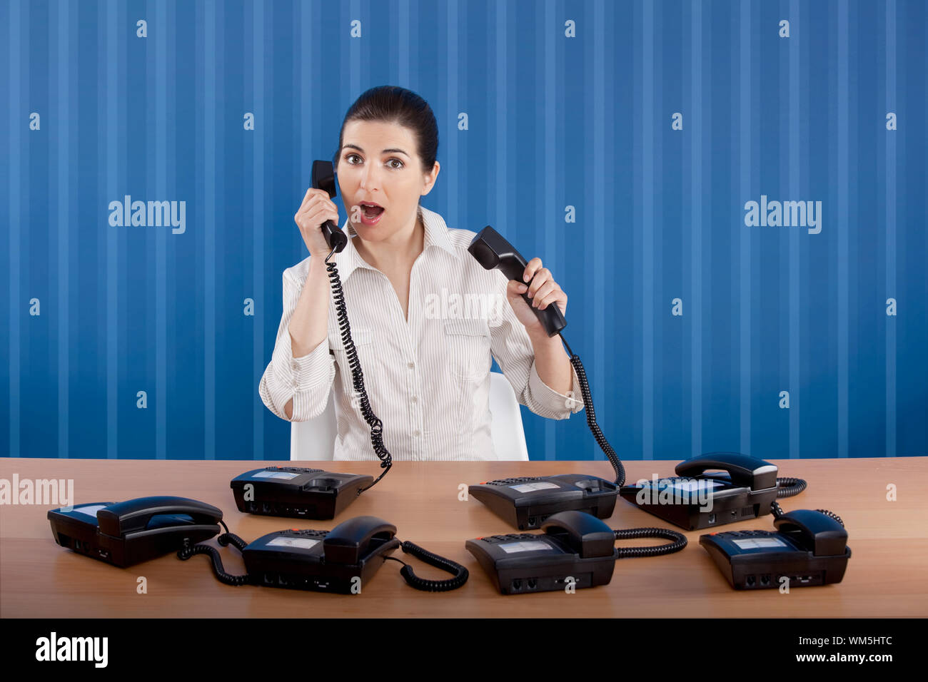 Businesswoman answering a lot of calls at the same time Stock Photo - Alamy
