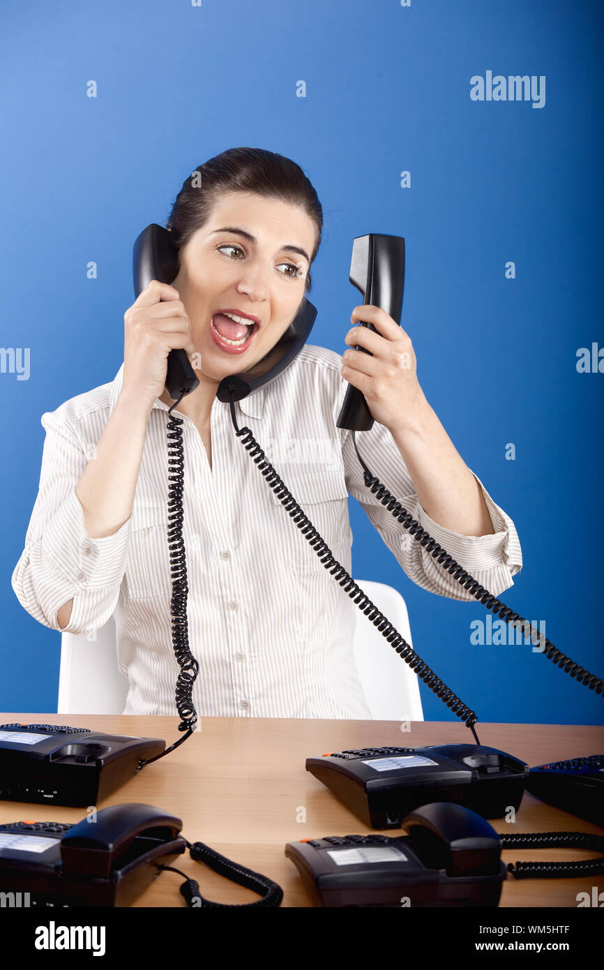 Businesswoman answering a lot of calls at the same time Stock Photo - Alamy
