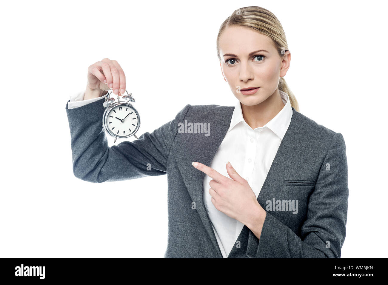 Female manager pointing at the alarm clock Stock Photo - Alamy