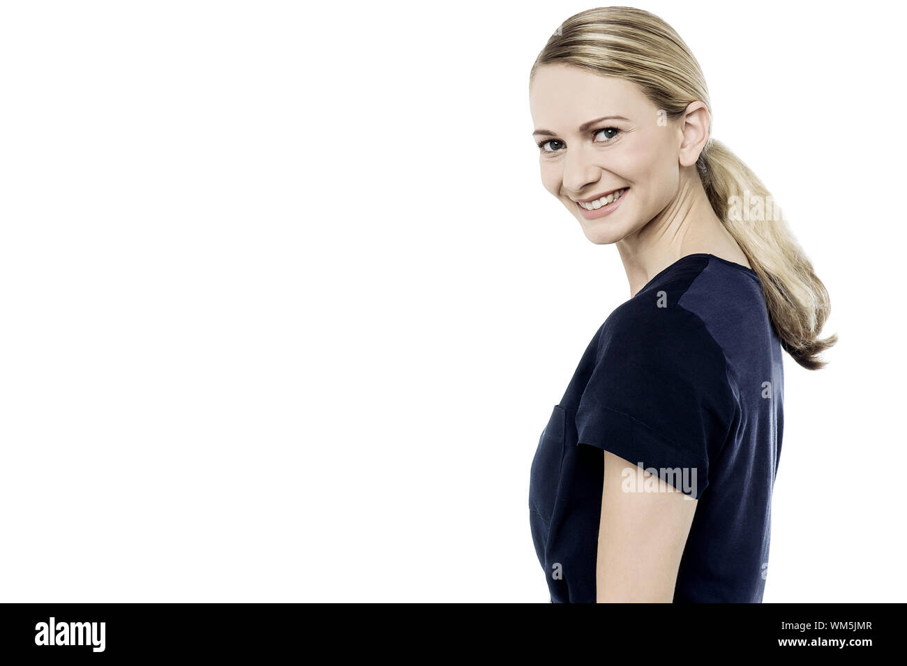 Side pose of woman looking at camera Stock Photo - Alamy