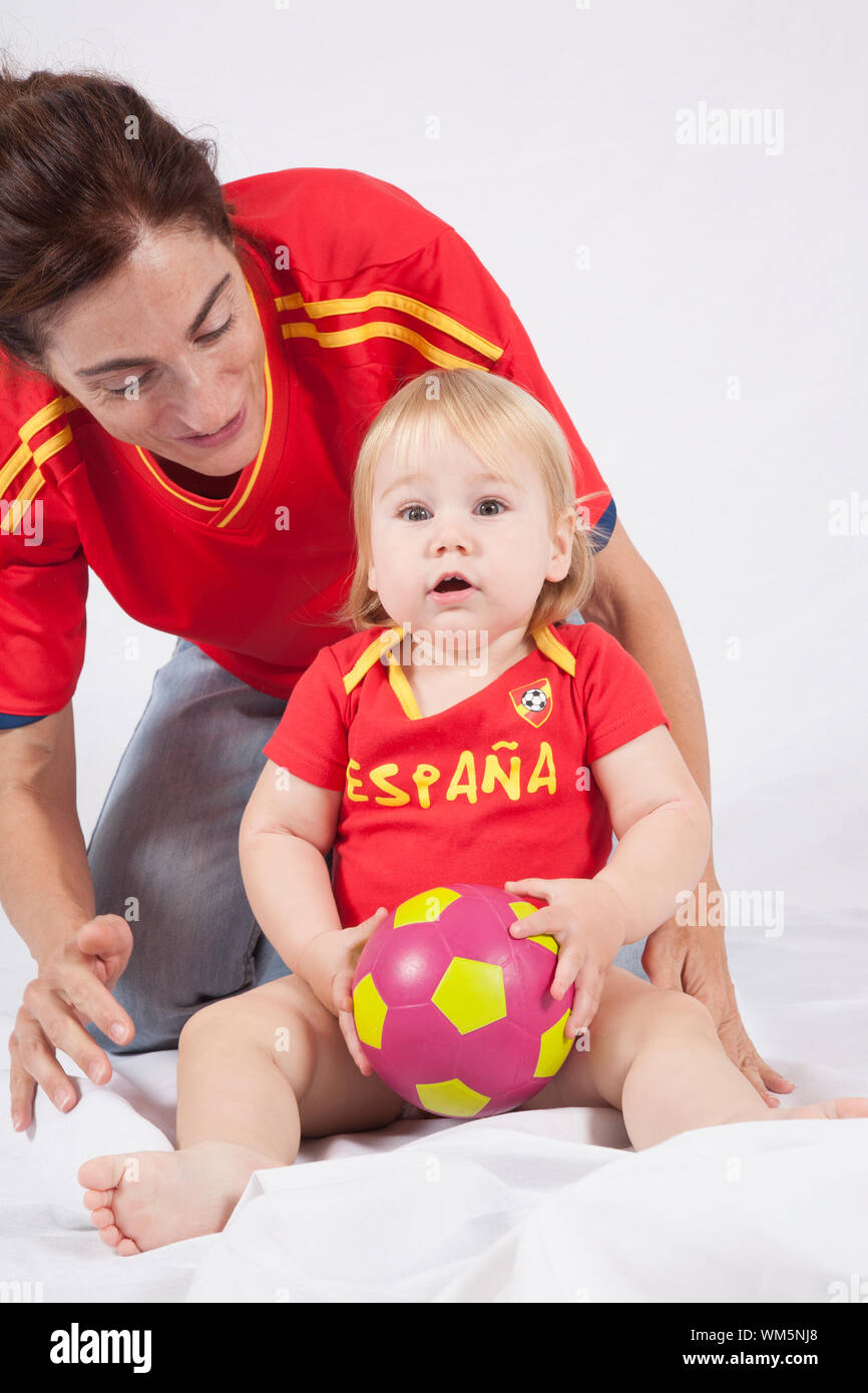 surprised face blonde baby sixteen month old with red shirt of Spanish ...