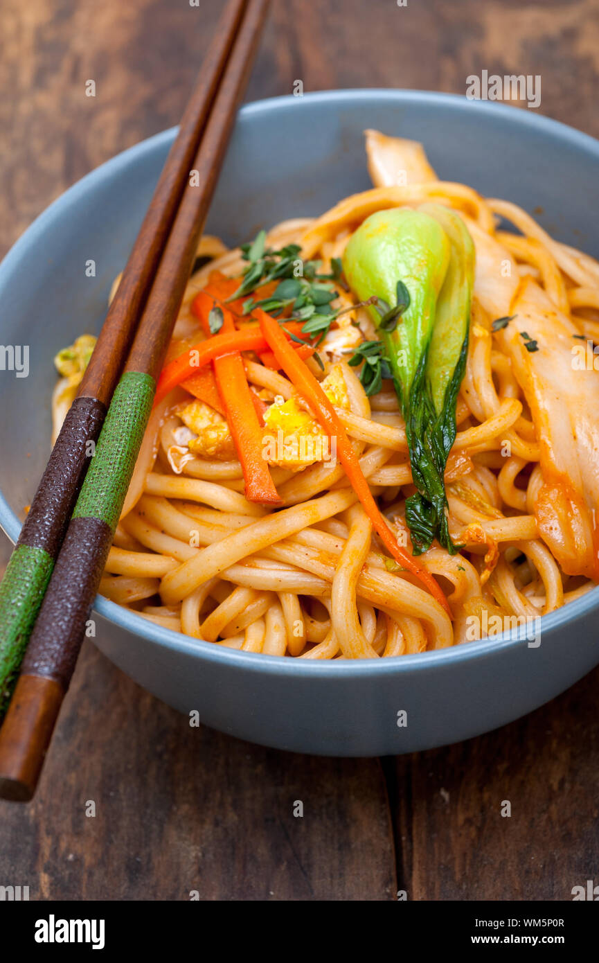 hand pulled stretched Chinese ramen noodles on a bowl with chopstick ...
