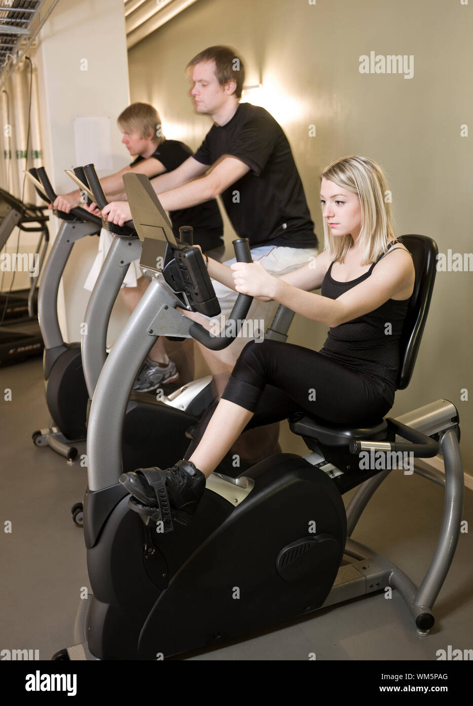 Three people spinning with a girl in focus Stock Photo - Alamy