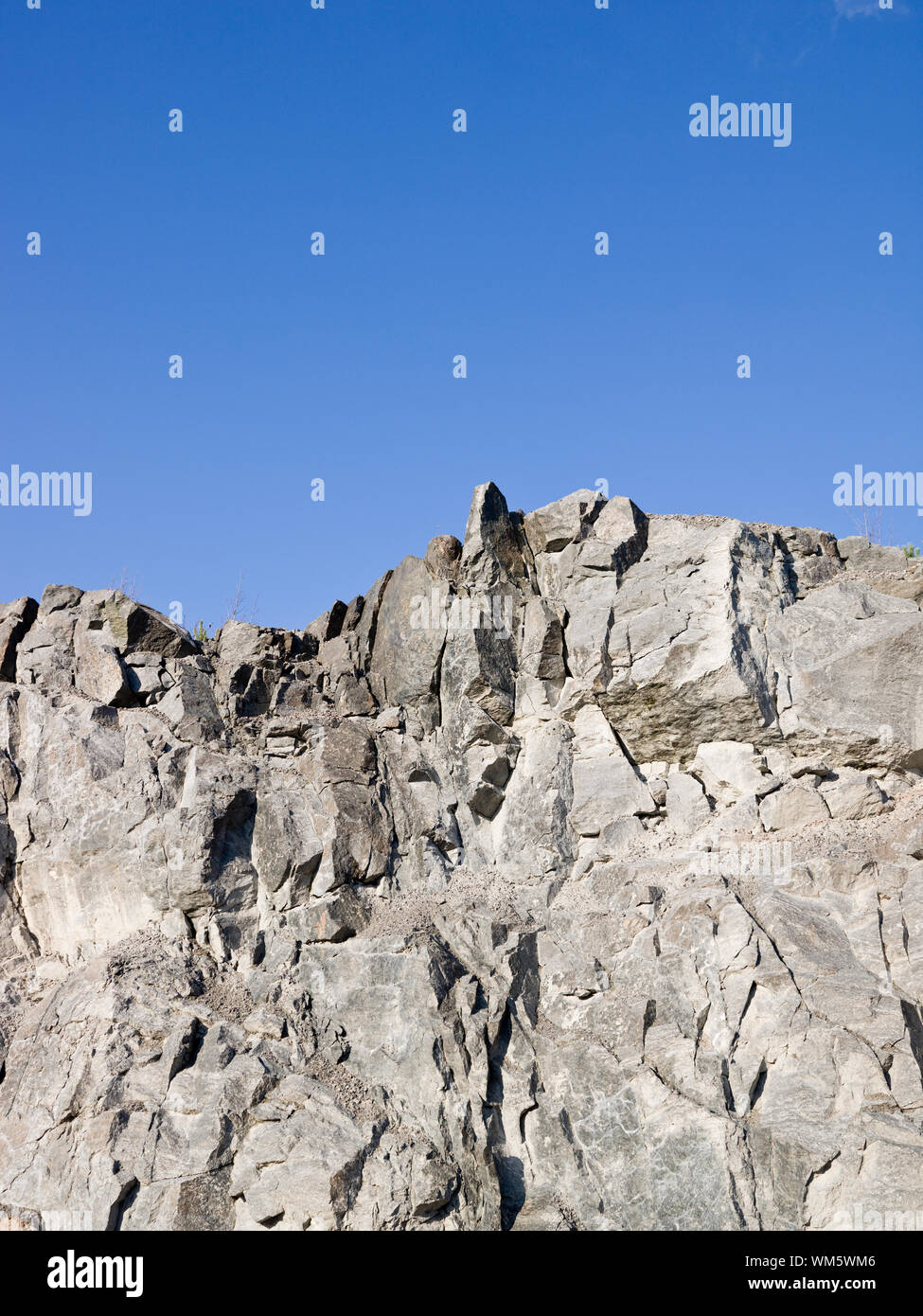 Rock formation against a clear blue sky Stock Photo - Alamy